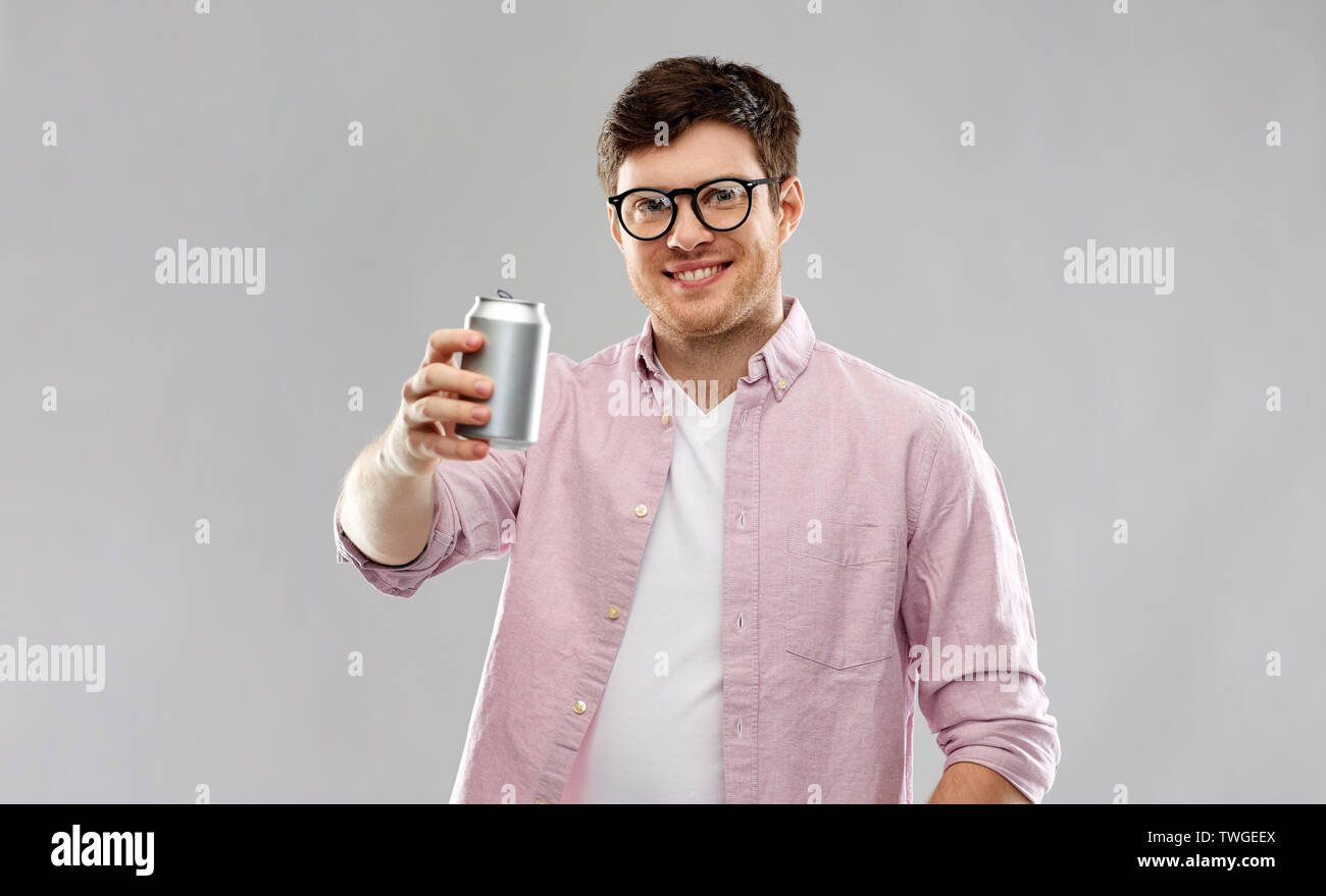happy young man drinking soda from tin can Stock Photo - Alamy