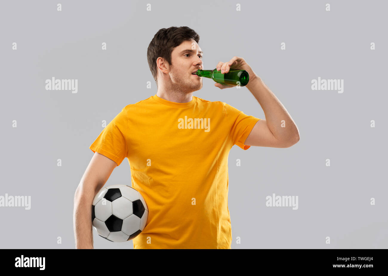 man or football fan with soccer ball drinking beer Stock Photo - Alamy