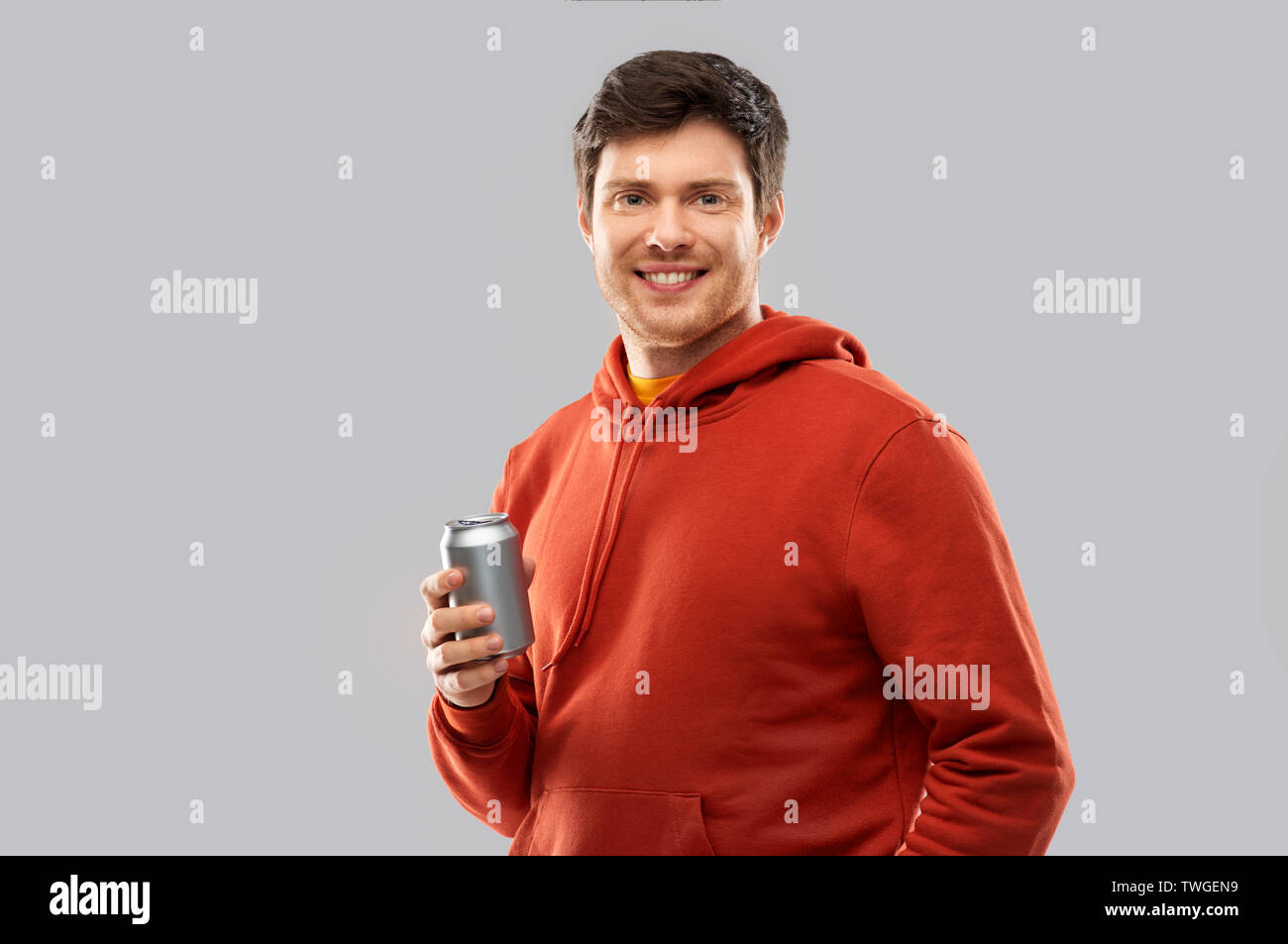 happy young man drinking soda from tin can Stock Photo - Alamy