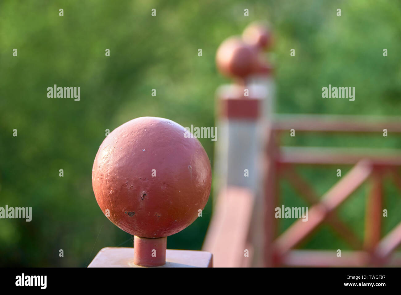 Red ball at a fence Stock Photo - Alamy