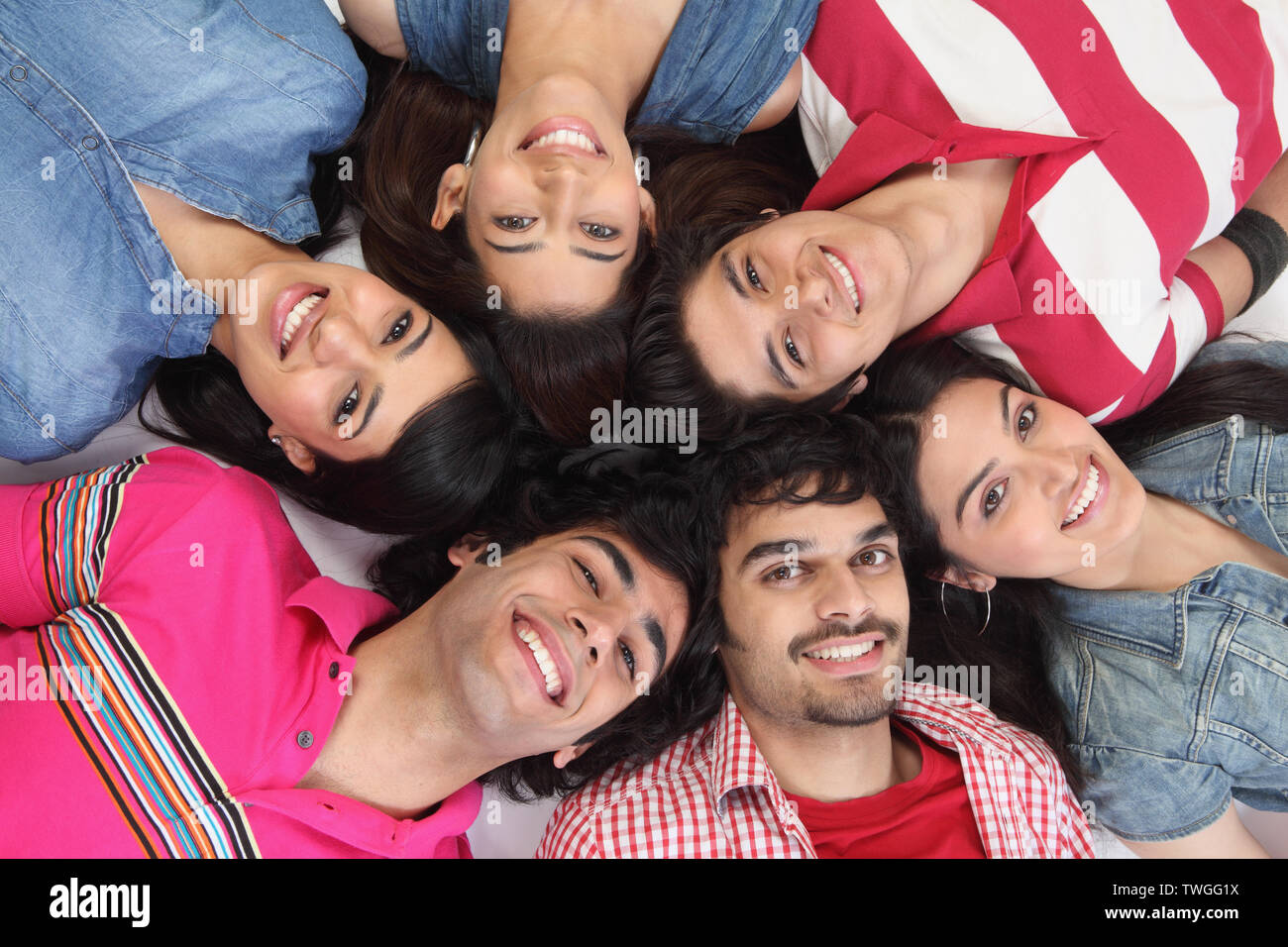 High angle view of group of friends lying down and smiling Stock Photo ...