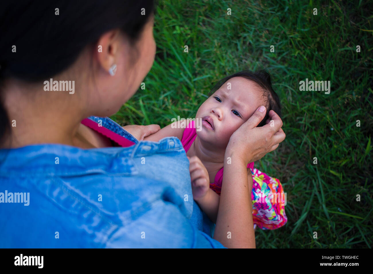 Young mother hugging and soothing a crying little daughter, Asian ... Young mother hugging and soothing a crying little daughter, Asian ...