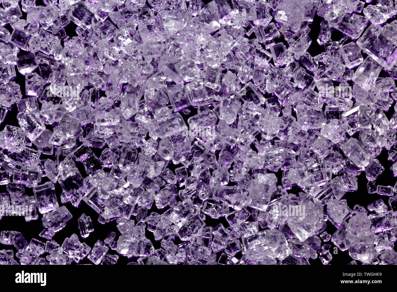 White sugar crystals on a dark violet background, macro, close-up Stock ...
