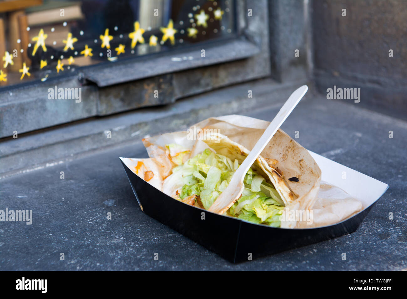 cardboard foof tray with left over food and disposable wooden fork ...