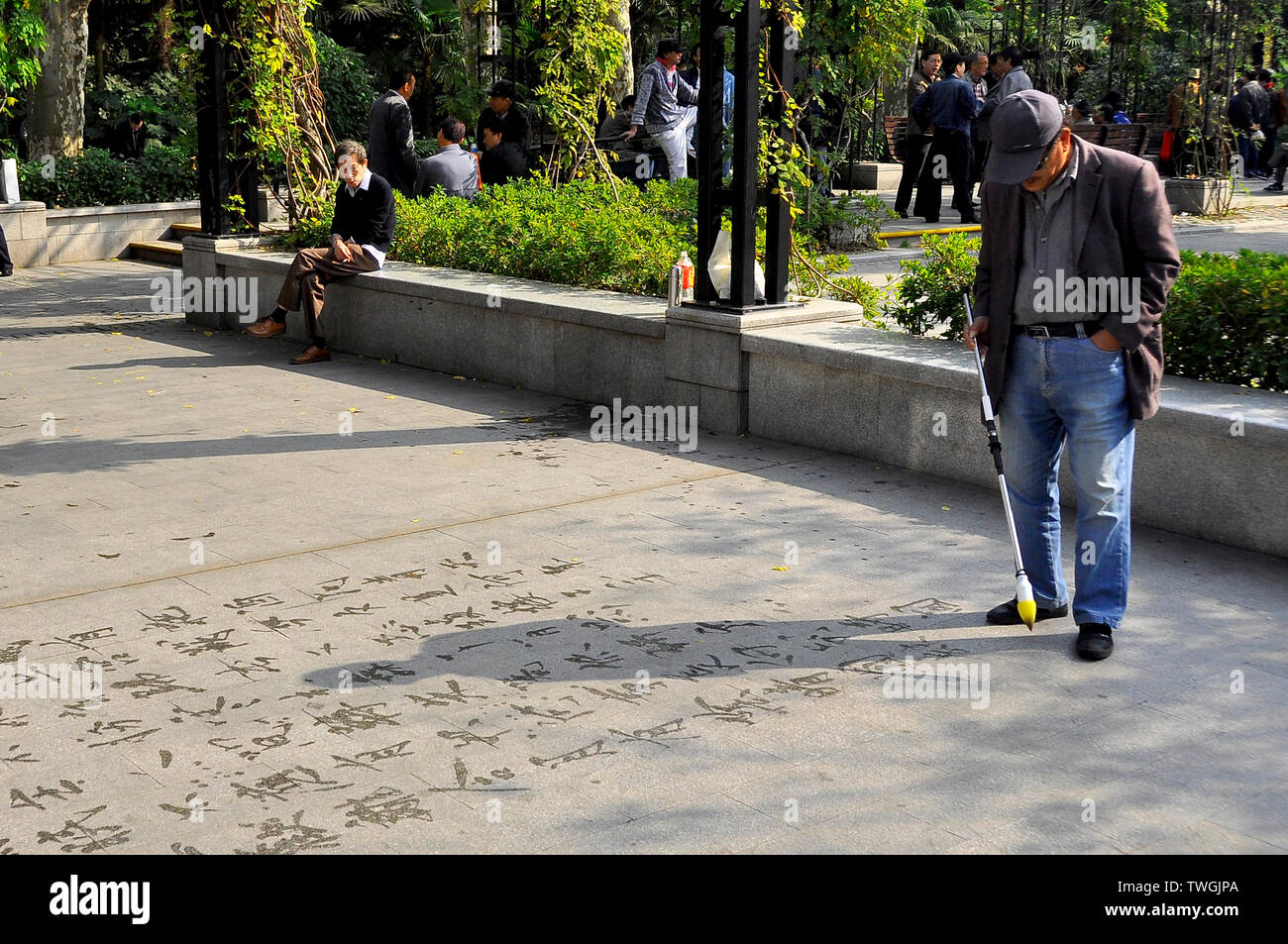 Chinese calligraphy artist writes script in water in a Shanghai park ...