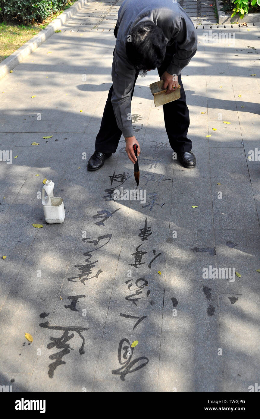 Chinese calligraphy artist writes script in water in a Shanghai park ...