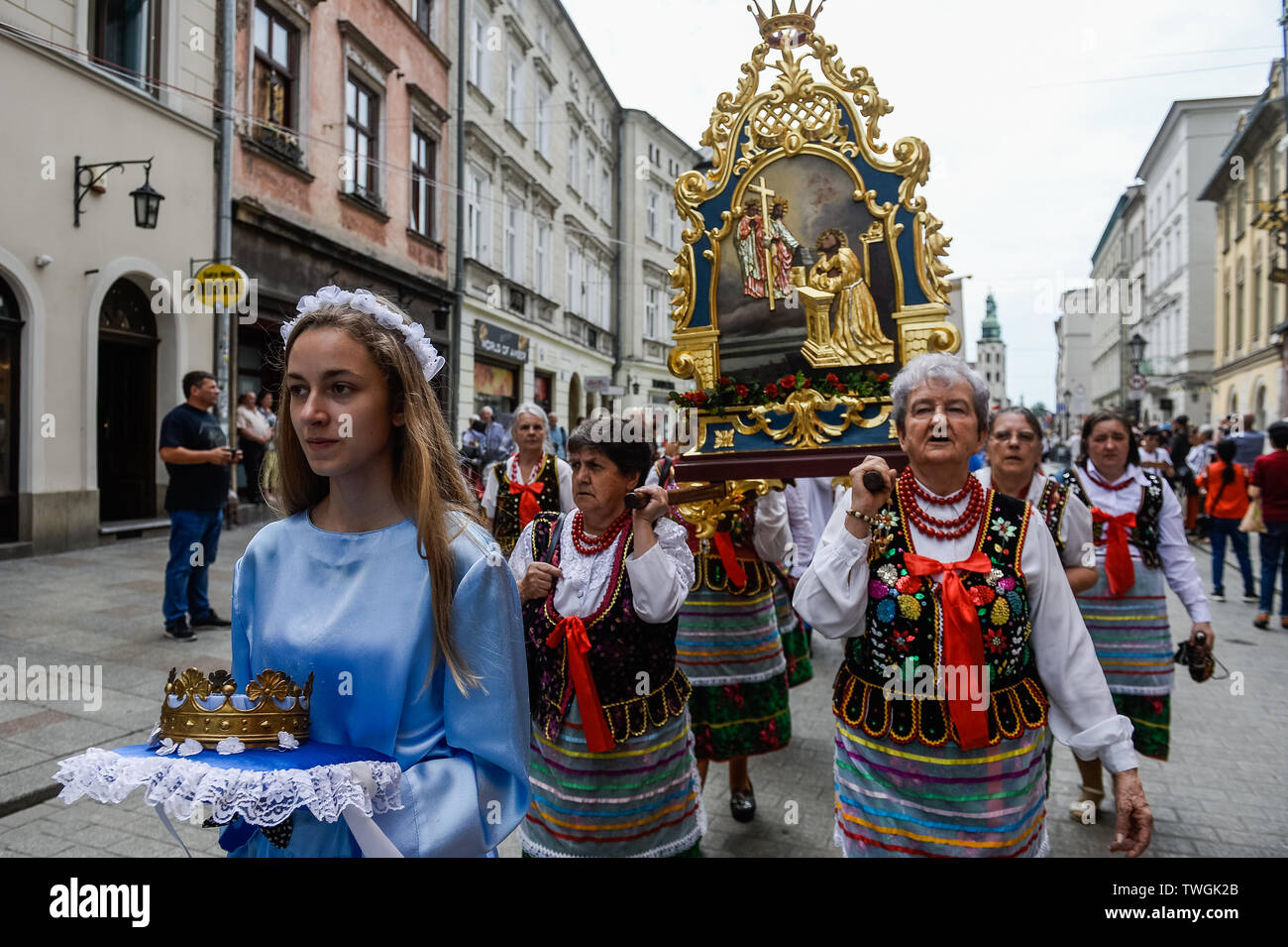 Women dressed in polish folk clothes carry a religious artefact during ...