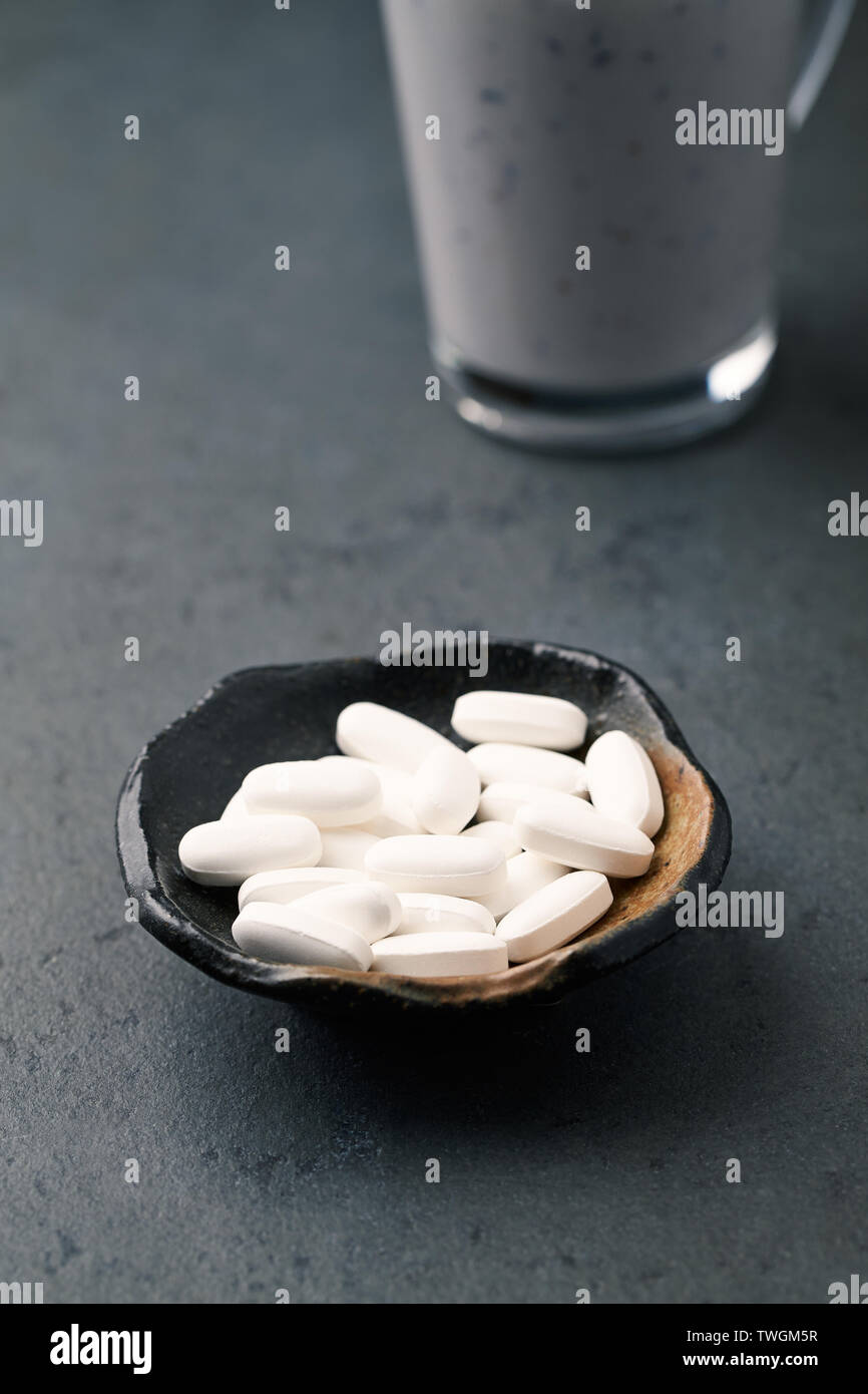 BCAA amino acids and a glass of protein shake with milk and bilberries ...