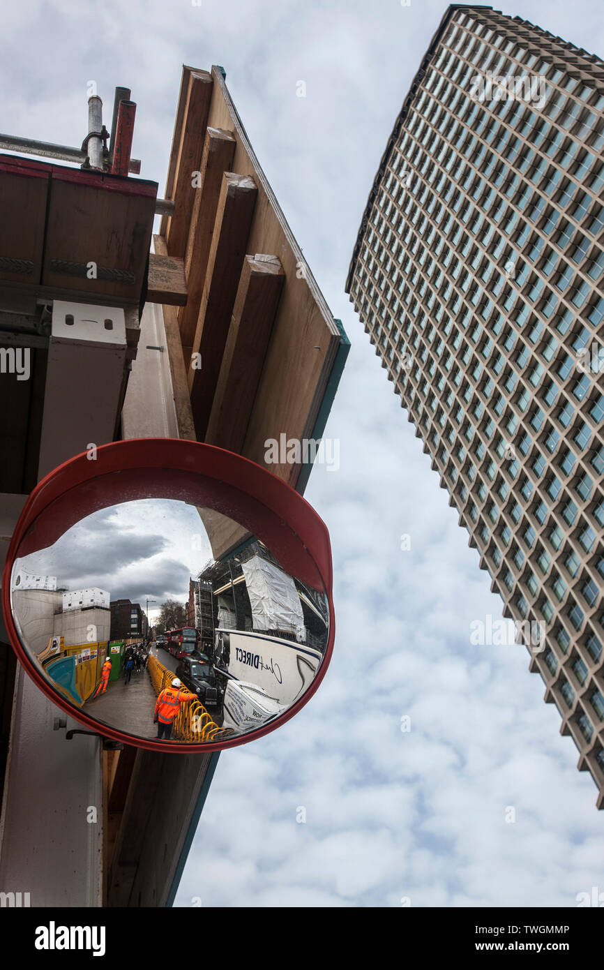 construction workers seen in convex mirror at tottenham court road ...
