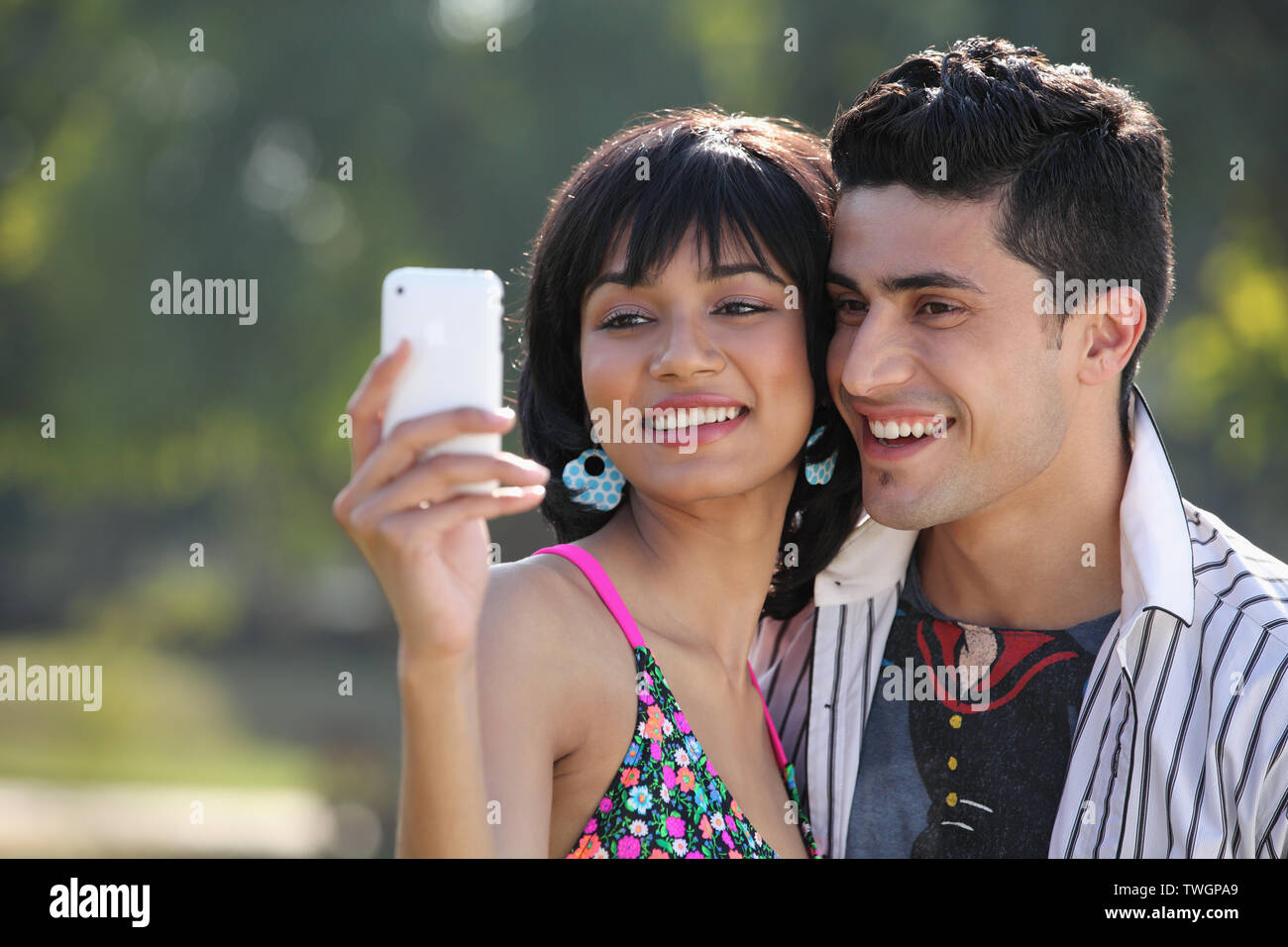 Couple text messaging and smiling Stock Photo - Alamy