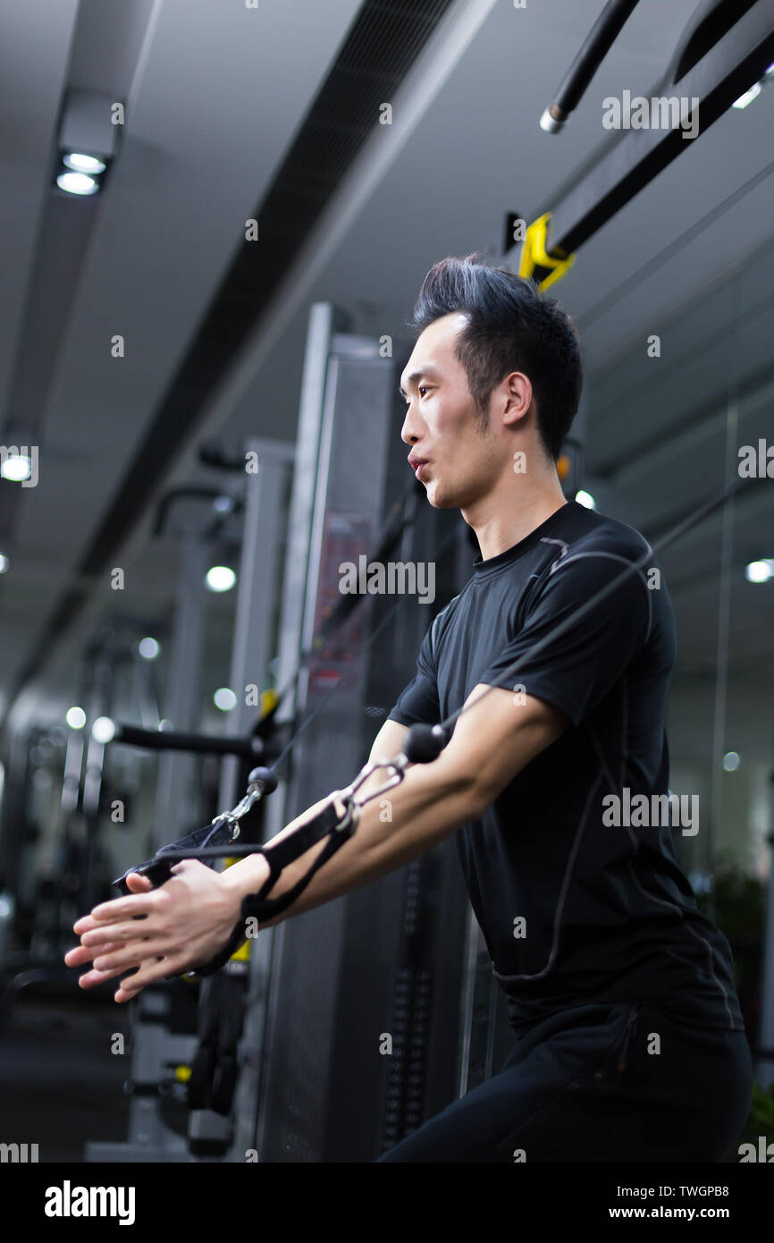 young asian man working out in modern gym Stock Photo - Alamy