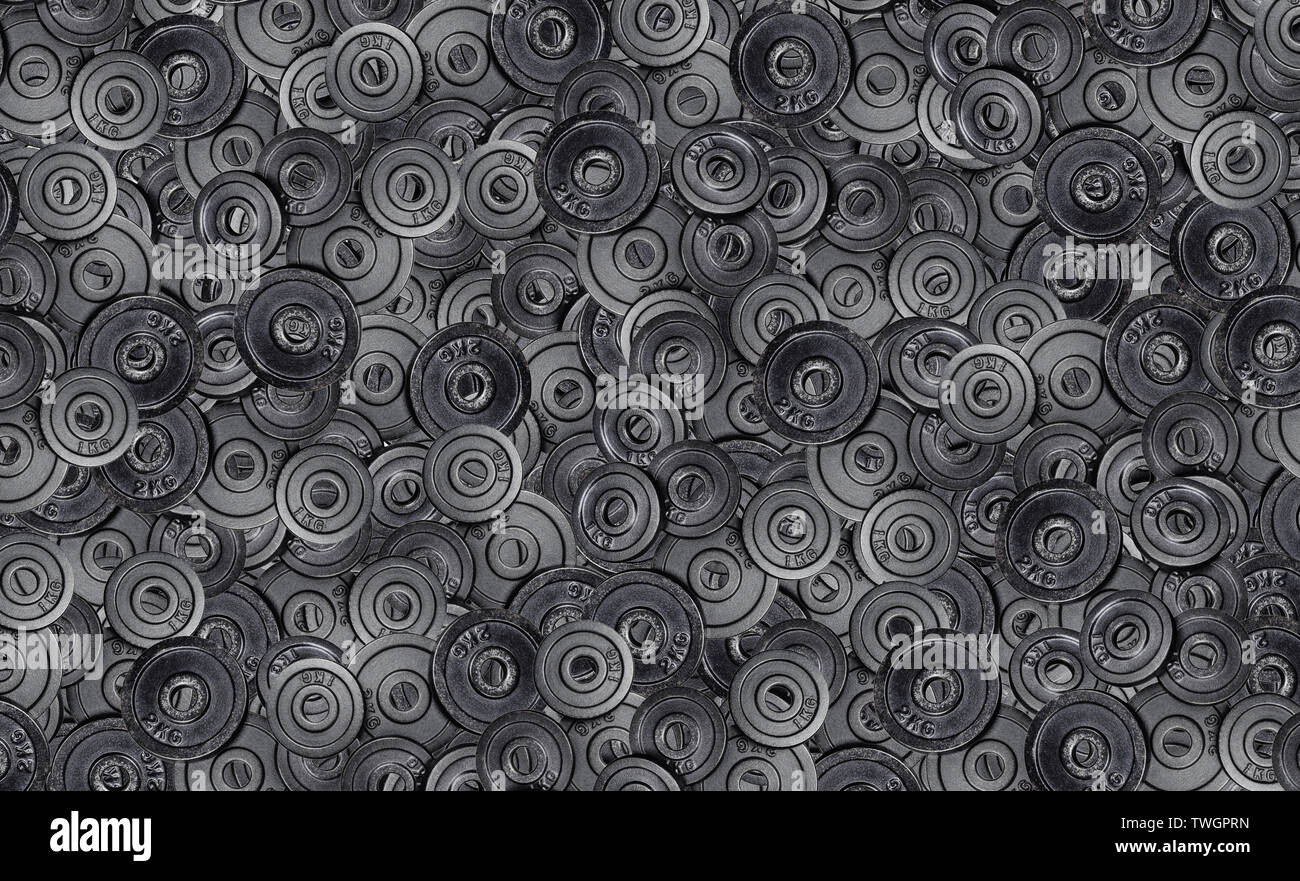 Pattern made from a stack metal weights 1kg and 2kg. Top view, flat lay ...