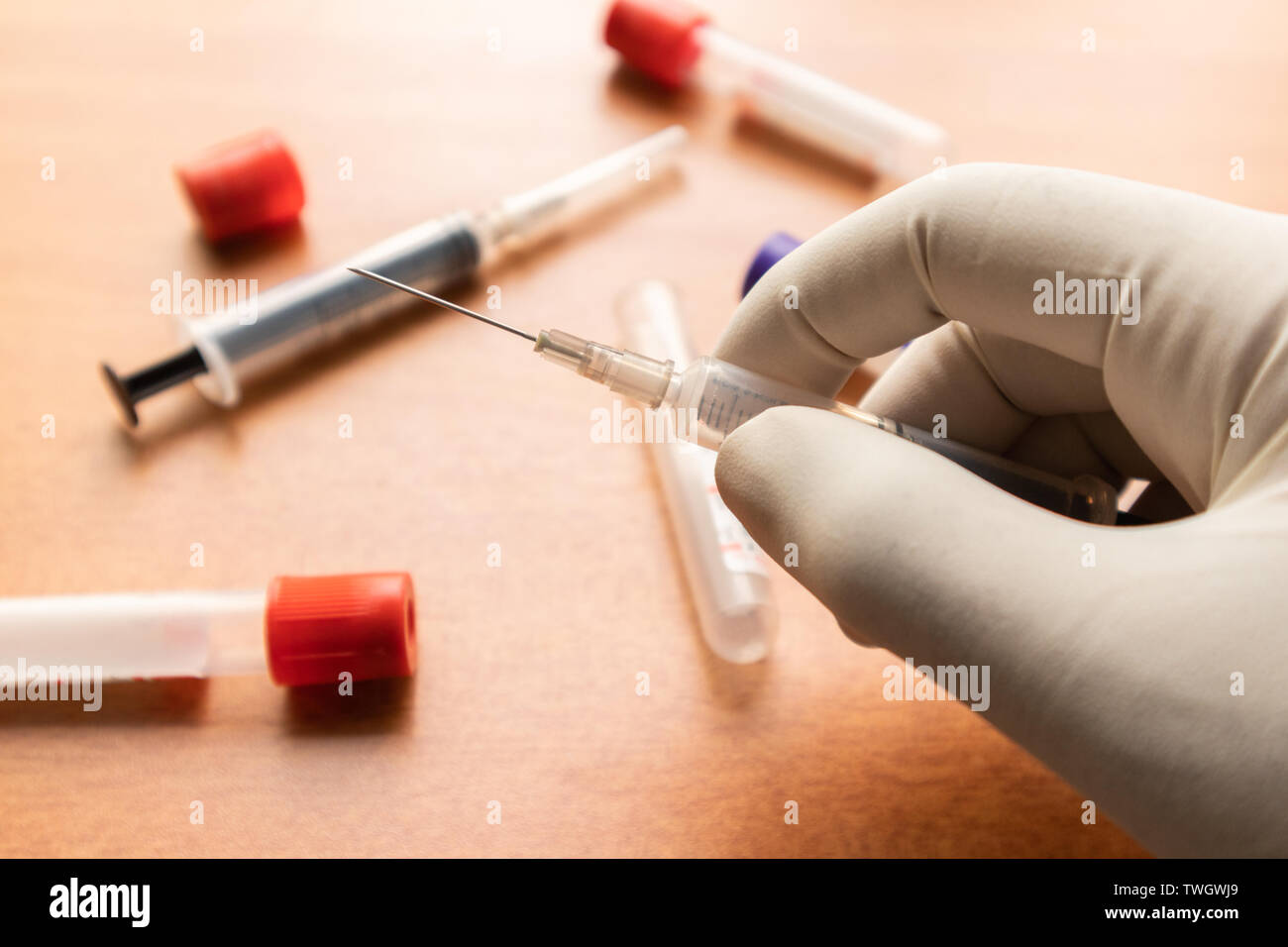 Doctor hand in white glove holding syringe, to get blood sample in ...