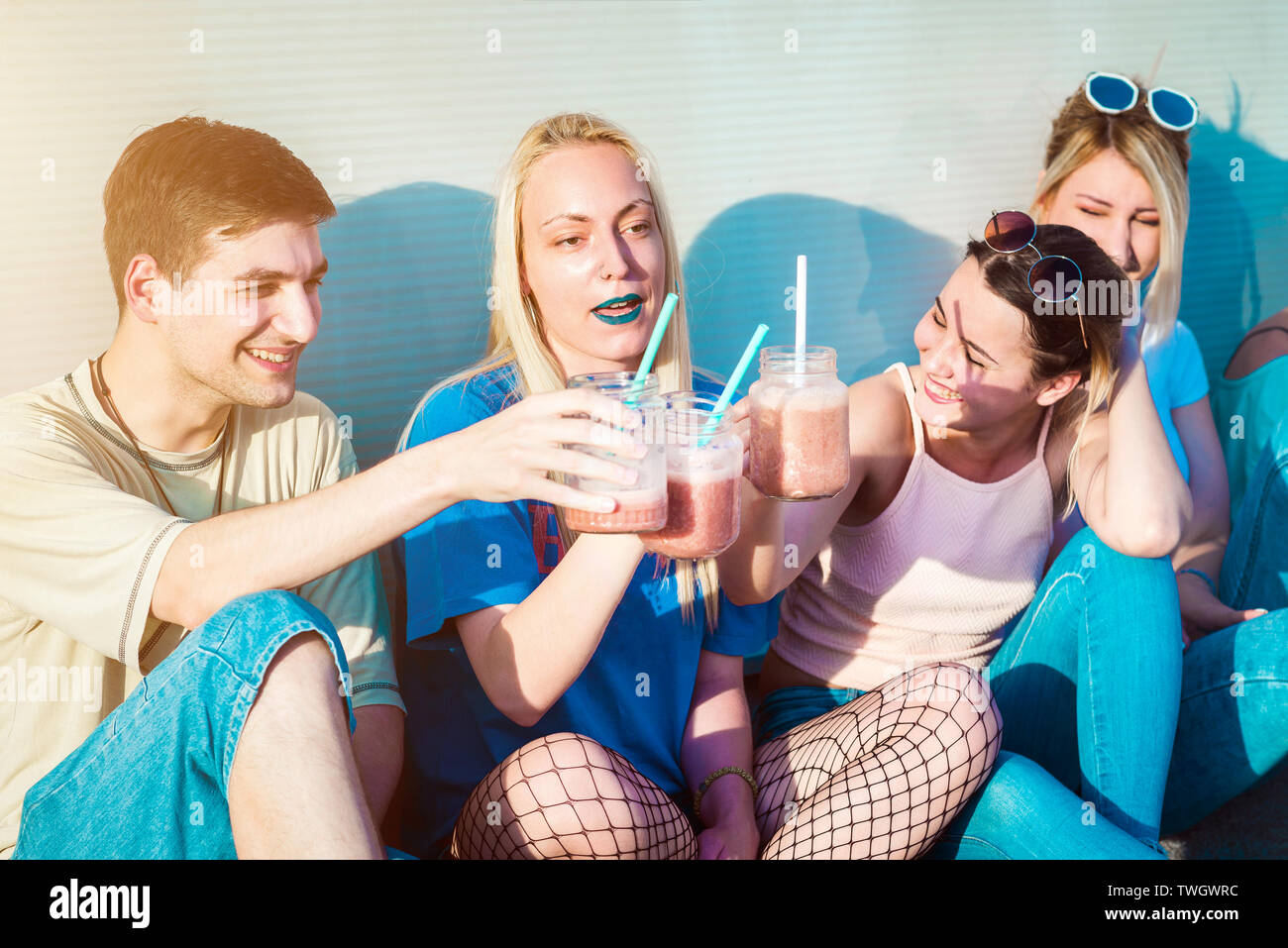 Group of young friends people cheering with smoothie drinks Stock Photo ...