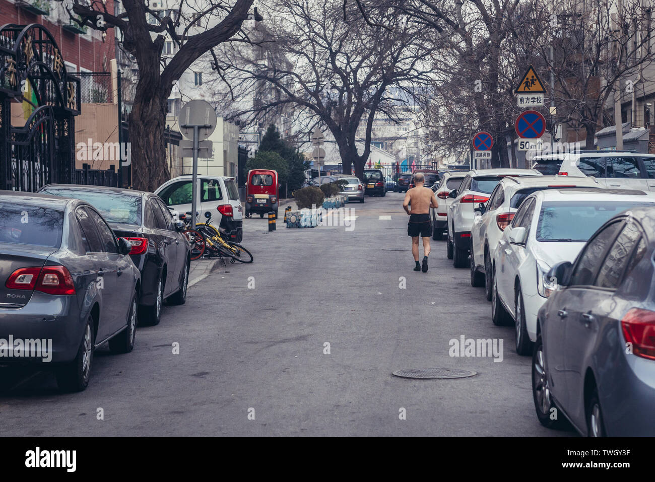 Old man running on a street in Beijing, China Stock Photo - Alamy