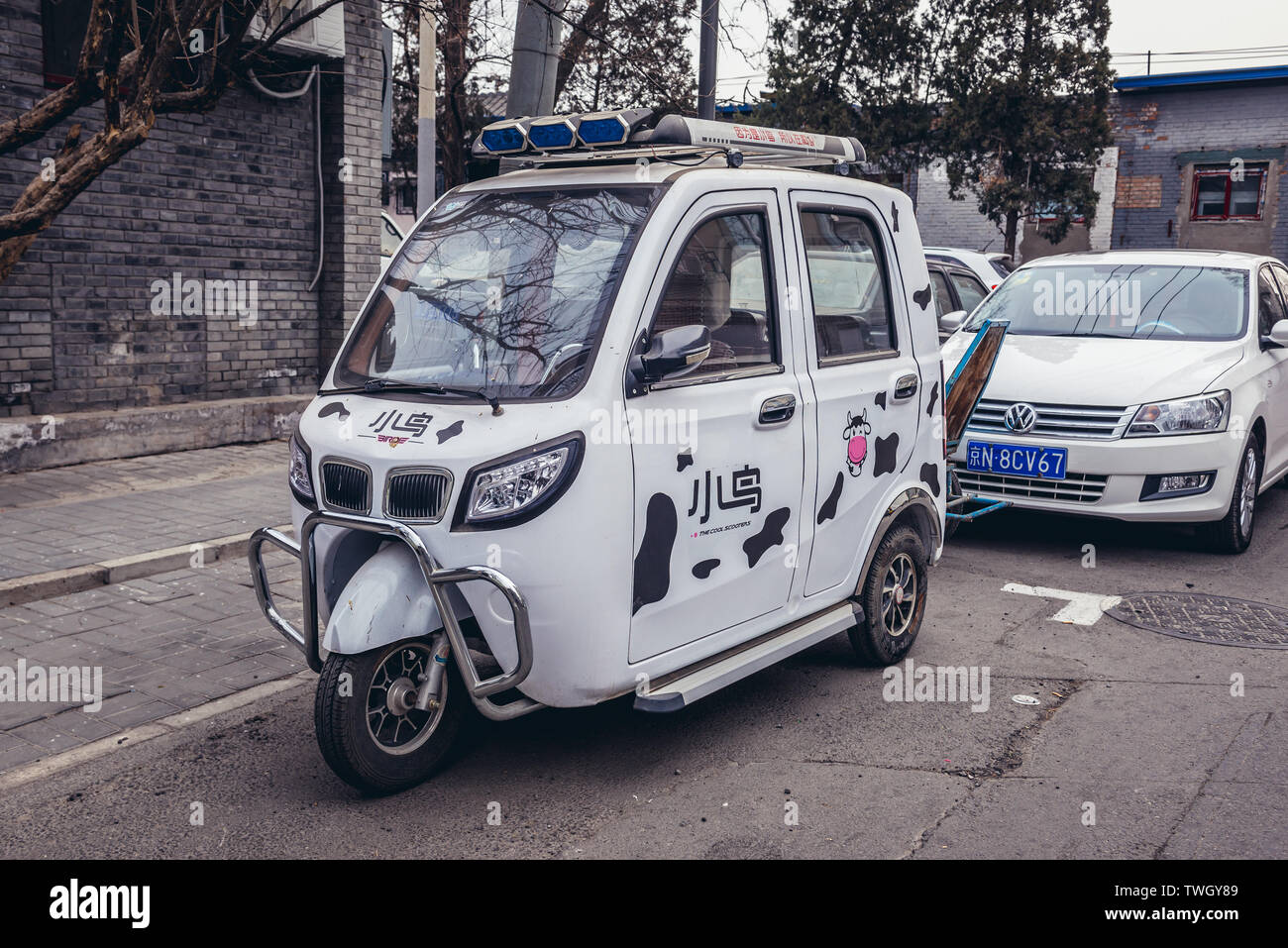 Three-wheeled vehicle in traditional hutong residential area in ...