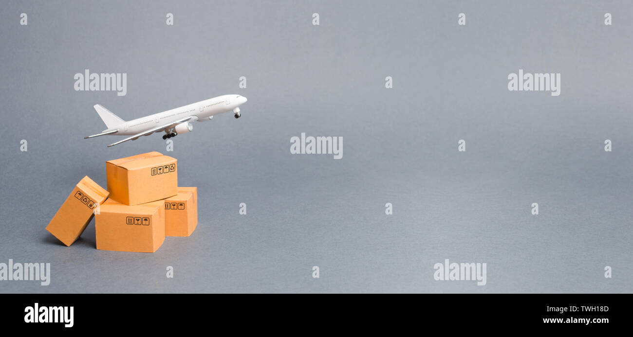 Airplane and stack of cardboard boxes. concept of air cargo and parcels ...