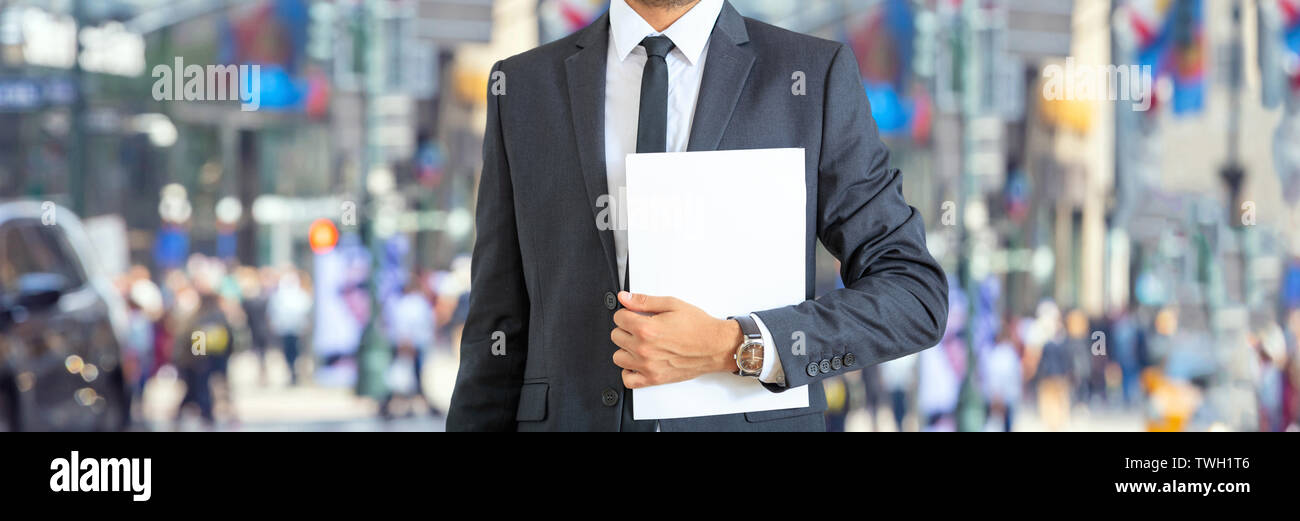 Busy man in suit holding documents. Blur crowded city street, banner ...