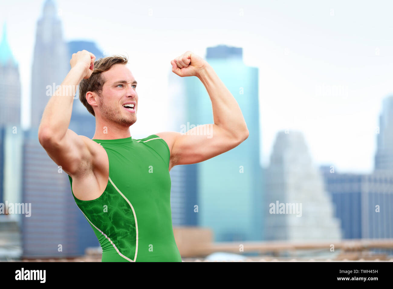 Winning cheering celebrating athlete fitness runner flexing muscles ...
