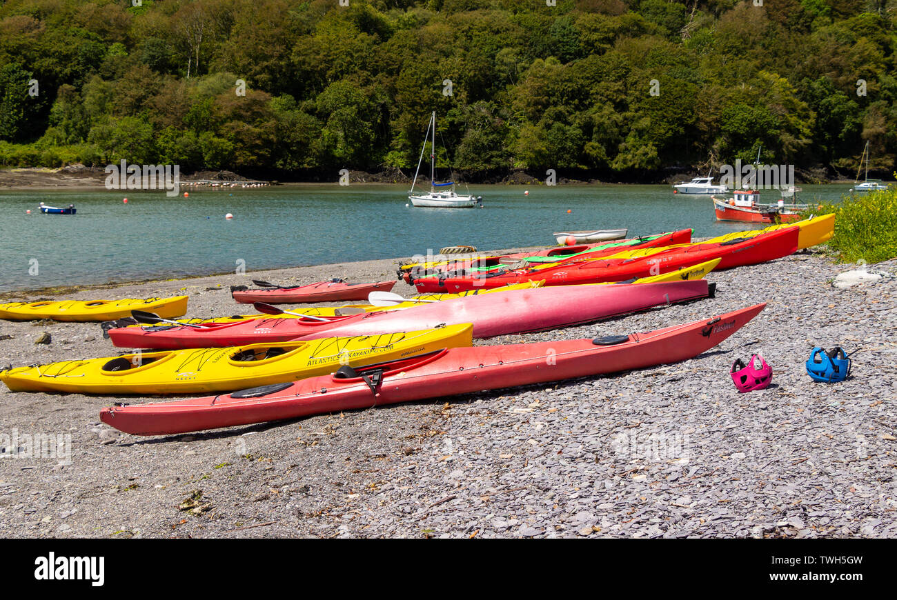 Kayaks and Safety helmet left on a shingle beach Stock Photo - Alamy