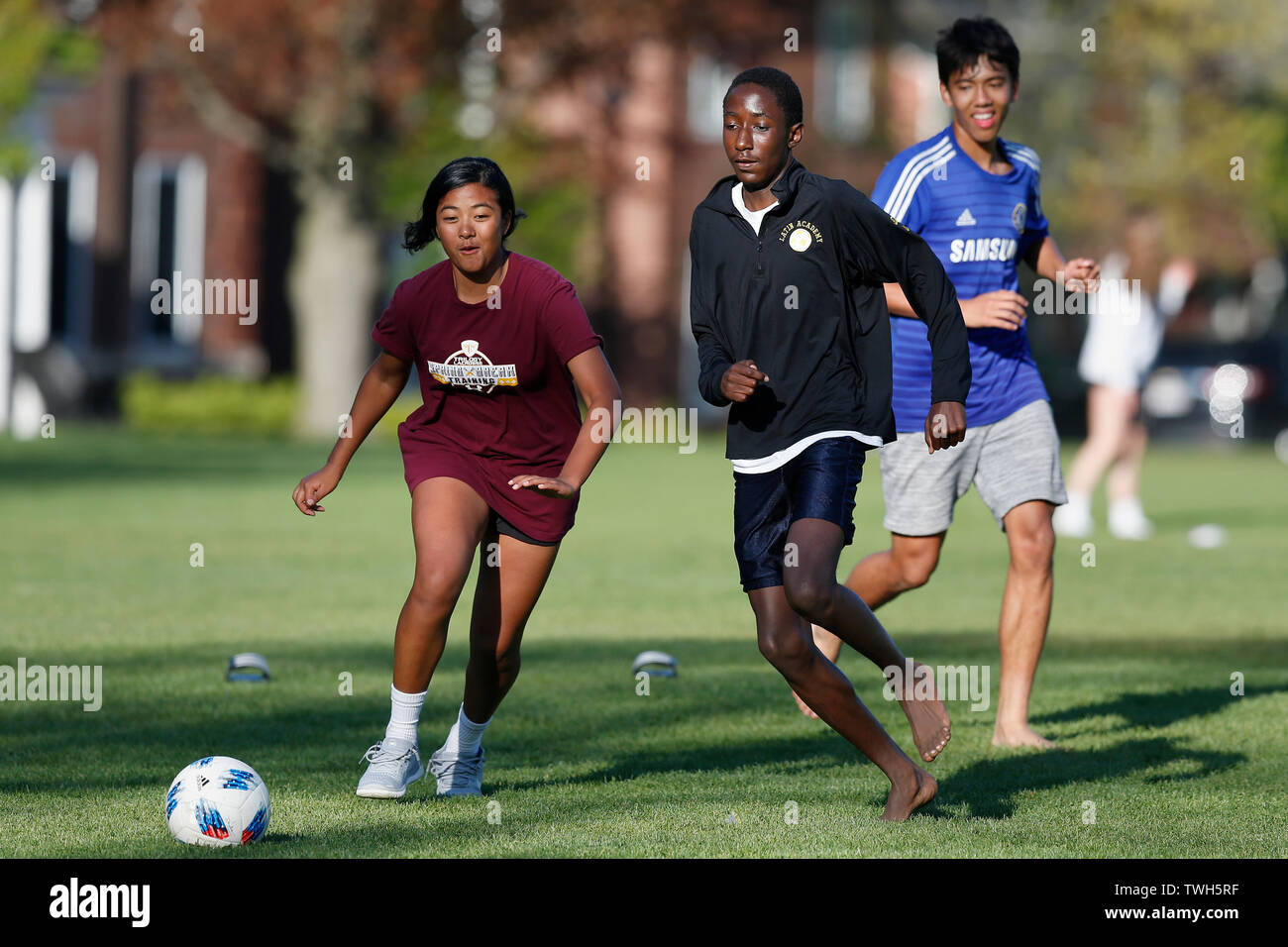 Teenagers playing football hi-res stock photography and images - Alamy