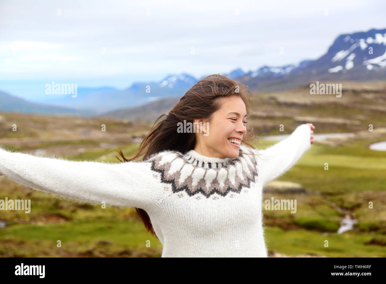 Happy free woman on Iceland in Icelandic sweater. Portrait of girl ...