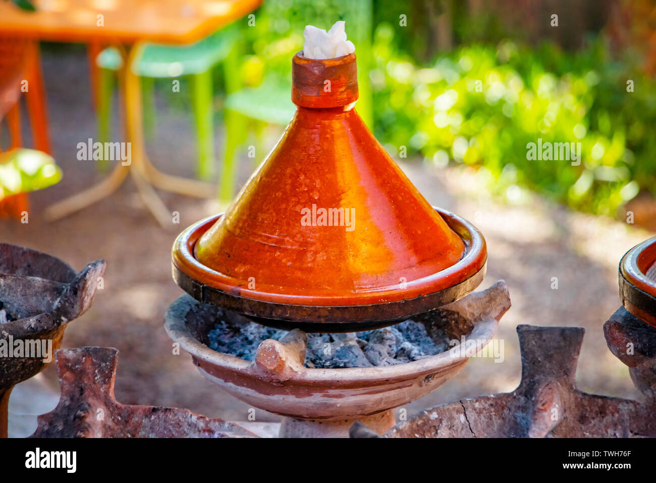 Cooking of traditional Moroccan tajin dishes. This is meat and some ...