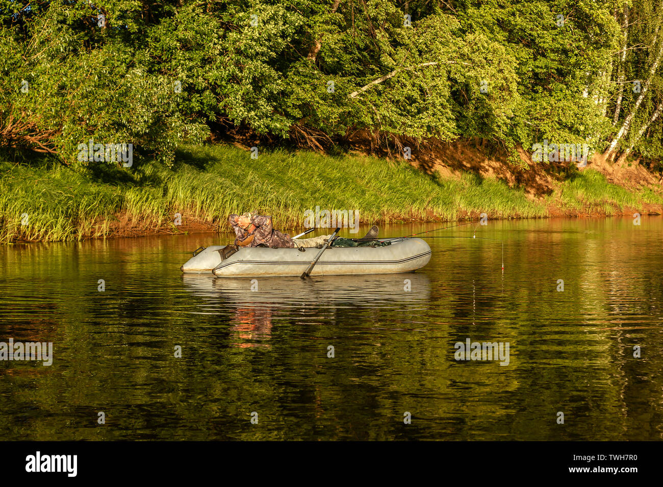 fisherman catch fish with a rubber boat Stock Photo - Alamy