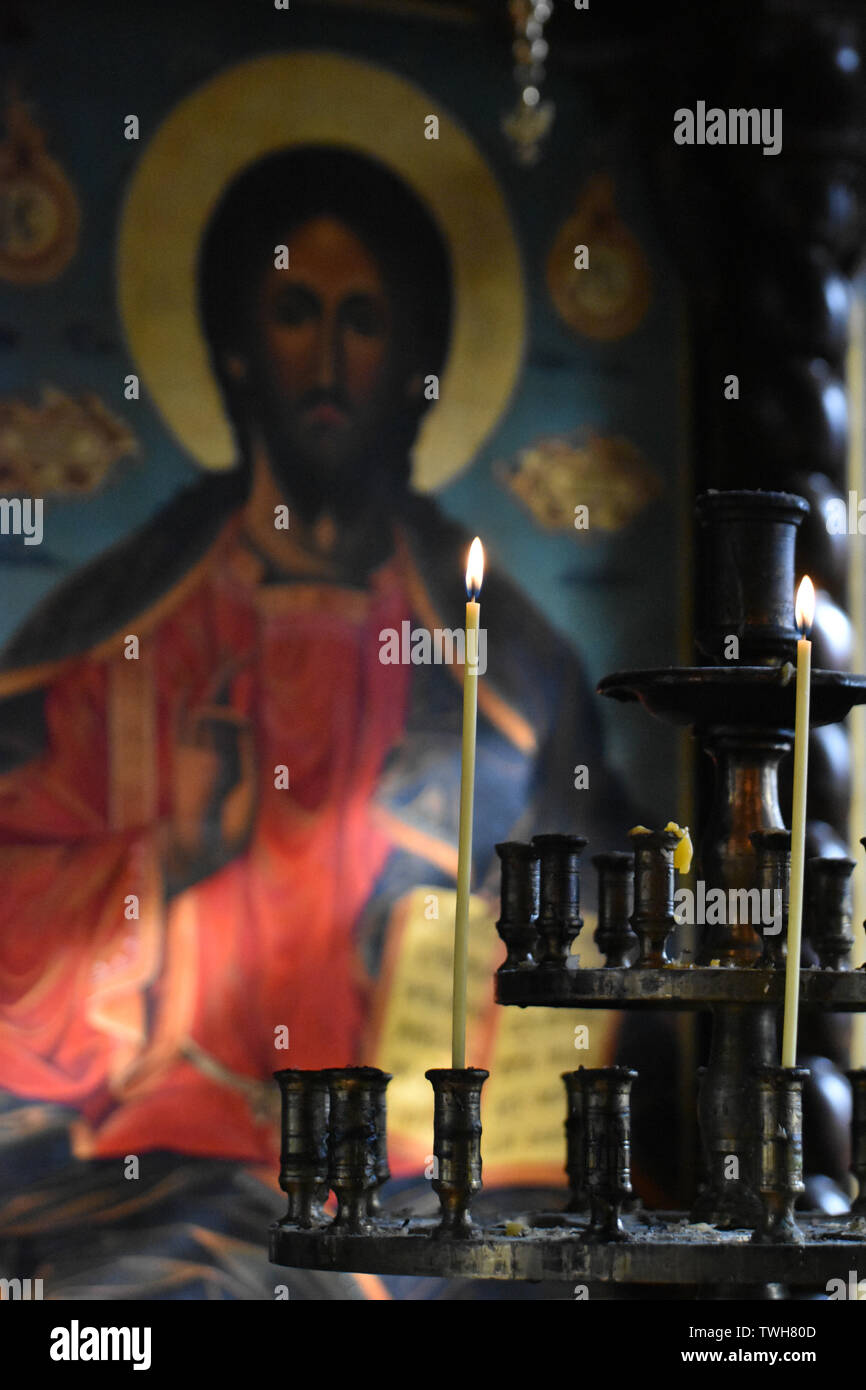 Candles burning in front of an icon of Jesus Christ in an orthodox ...