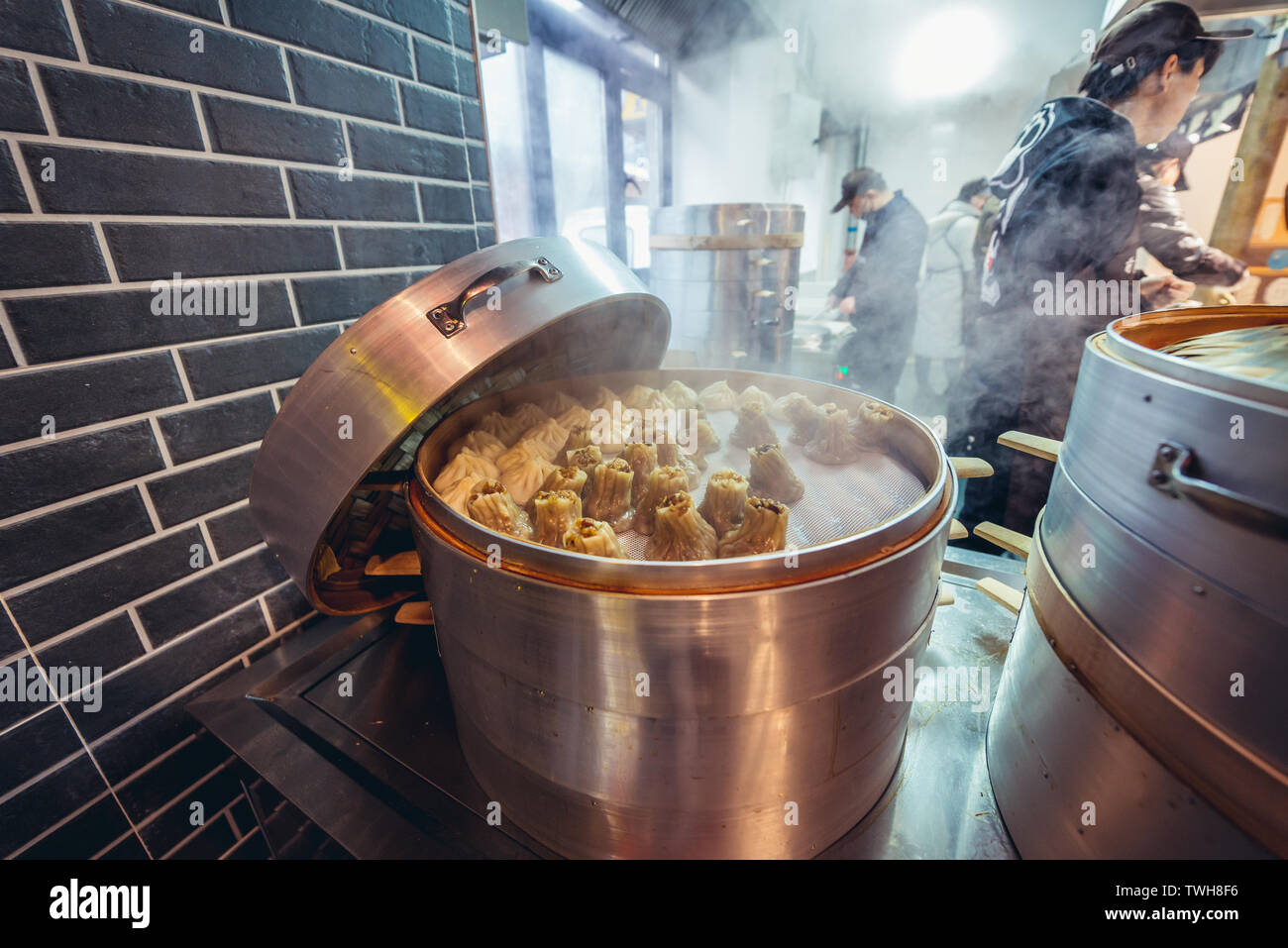 Steamed dumplings on a indoor food stand on Qianmen Street in Beijing ...