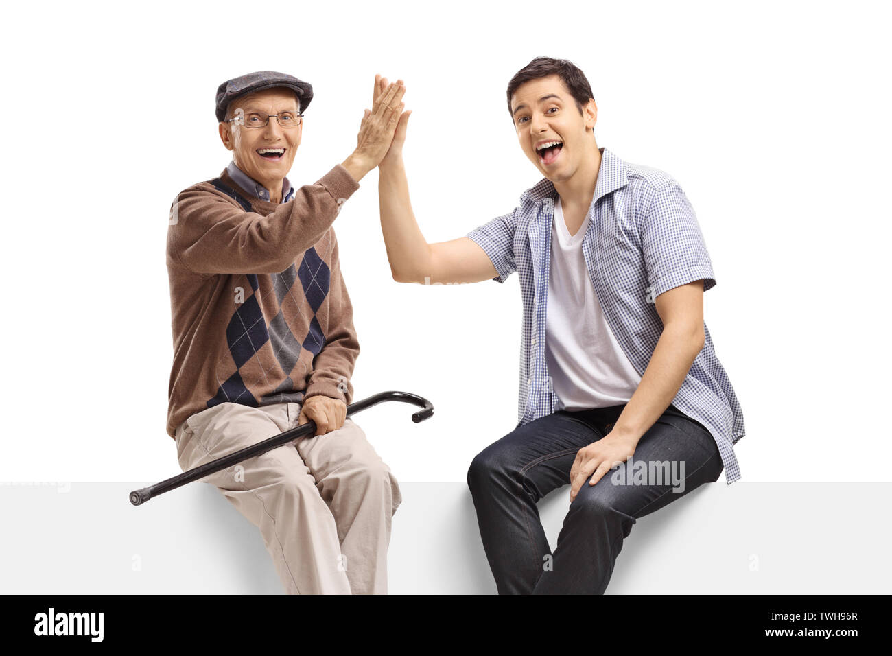 Cheerful senior man and a young man high-fiving each other on a panel ...