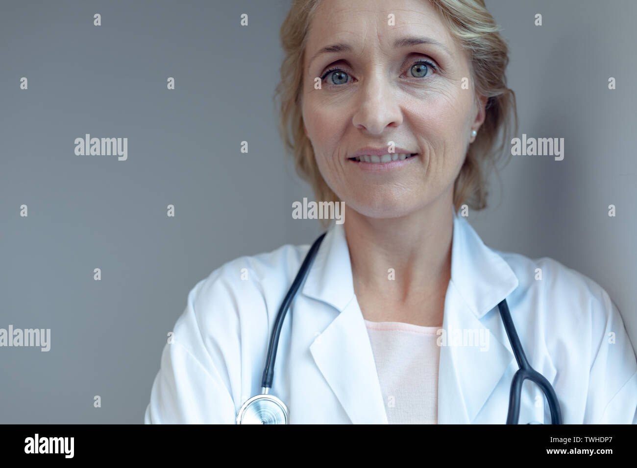 Female doctor smiling in the hospital Stock Photo - Alamy