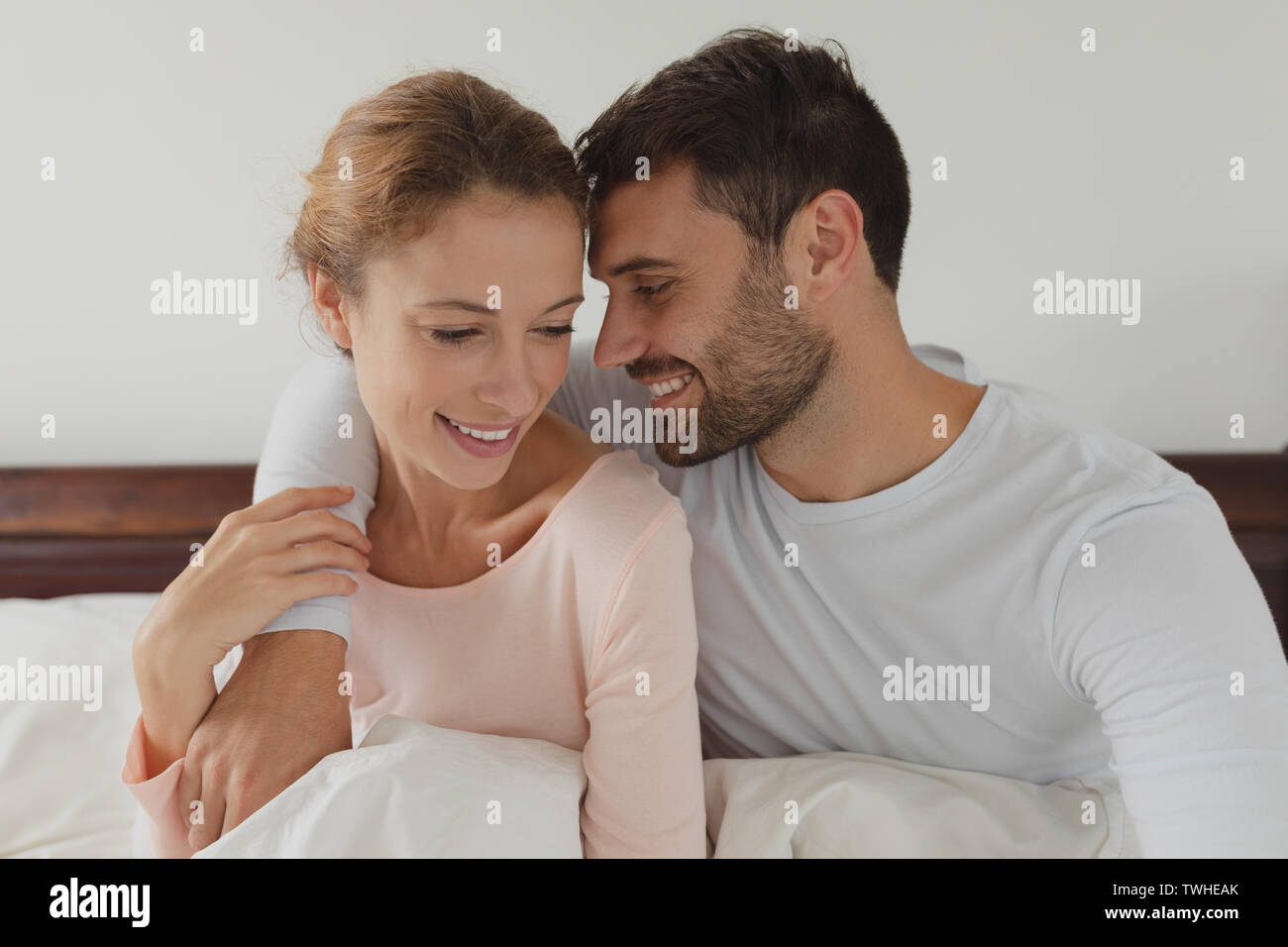 Romantic couple in bed in bedroom Stock Photo - Alamy
