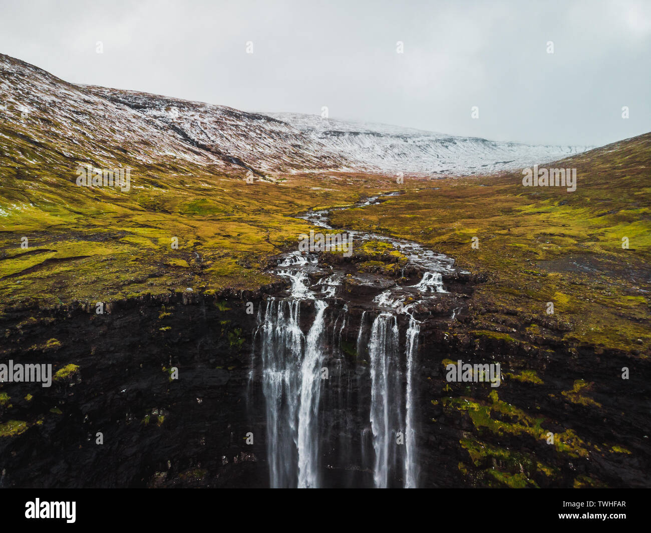 Aerial footage of Fossa waterfall from above during early spring with ...