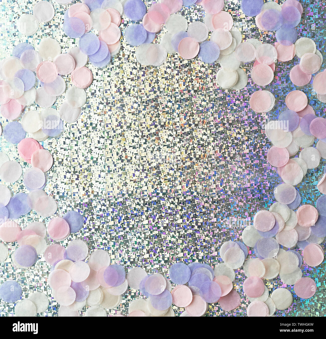 Frame of pastel colored confetti on shiny holographic background ...