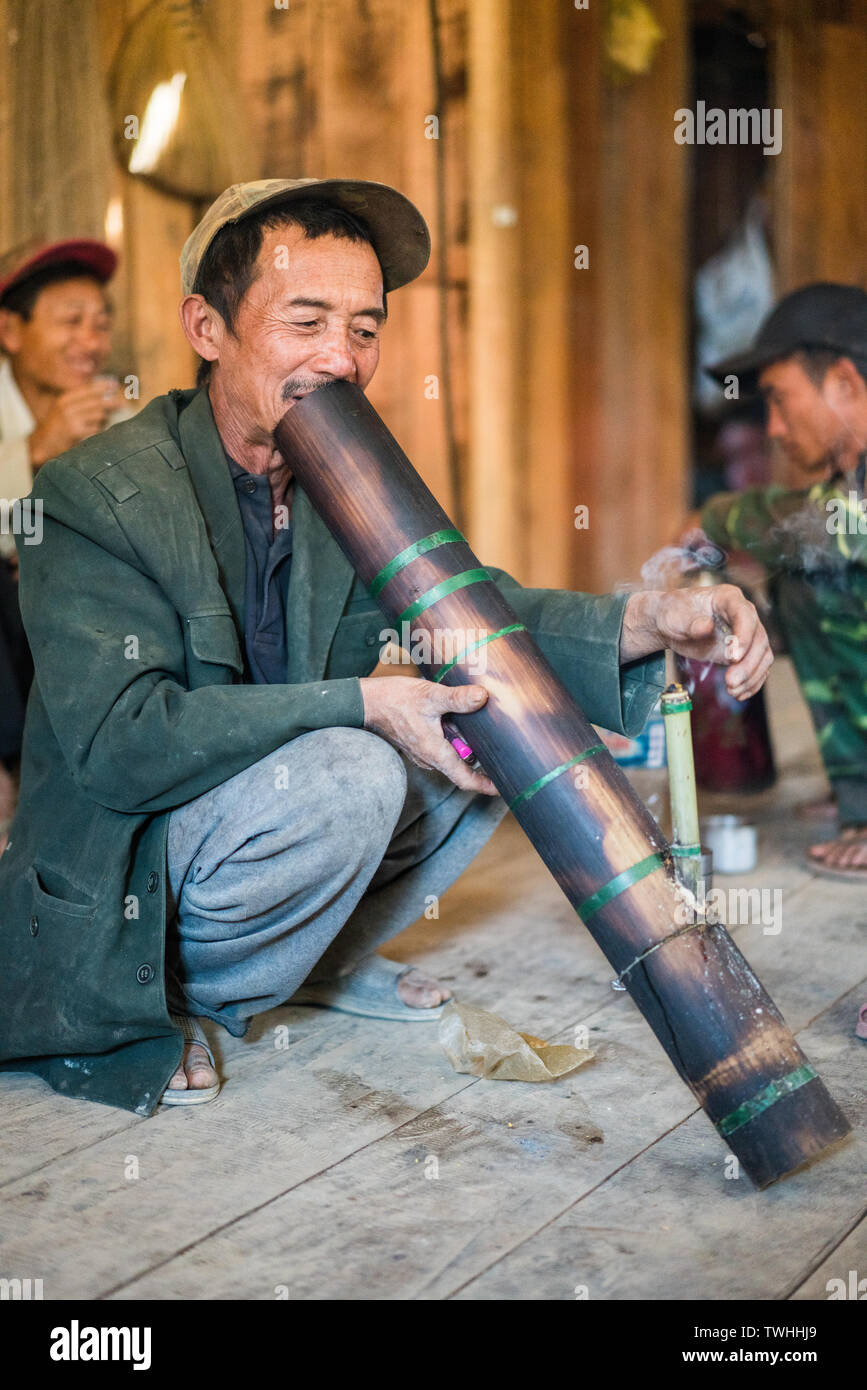 Man Smoking Opium By Traditional Tobacco Pipe In The Akha Pixor Village