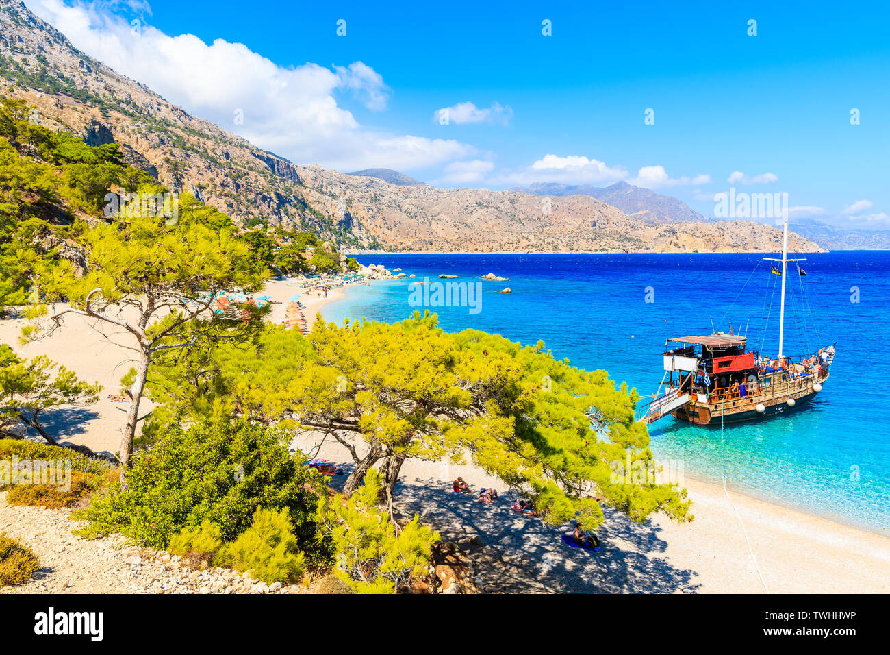 Tourist boat anchoring at beautiful Apella beach on Karpathos island ...