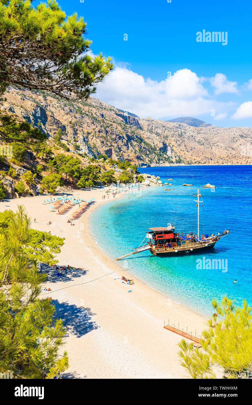 Tourist boat anchoring at beautiful Apella beach on Karpathos island ...
