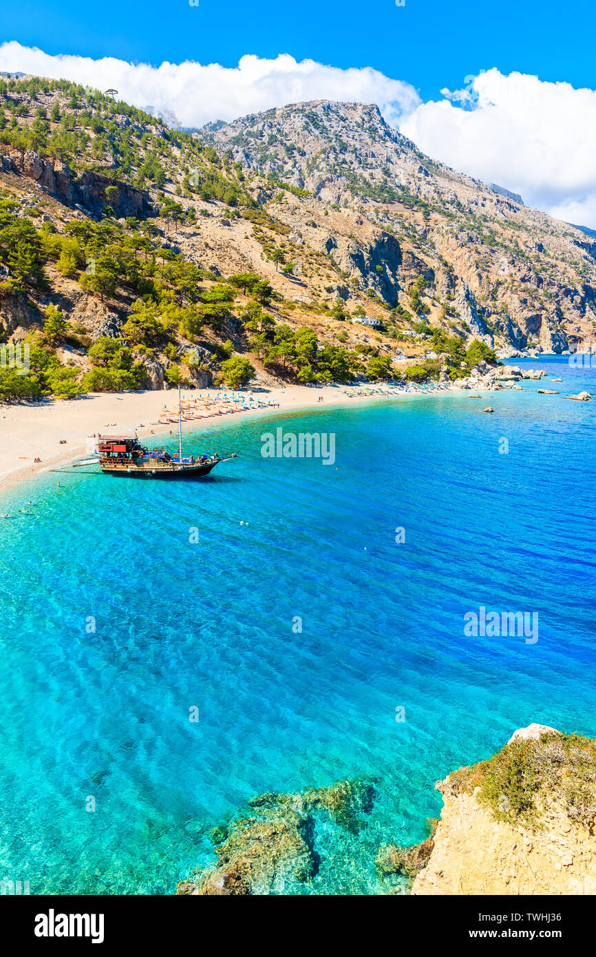 Tourist boat anchoring at beautiful Apella beach on Karpathos island ...