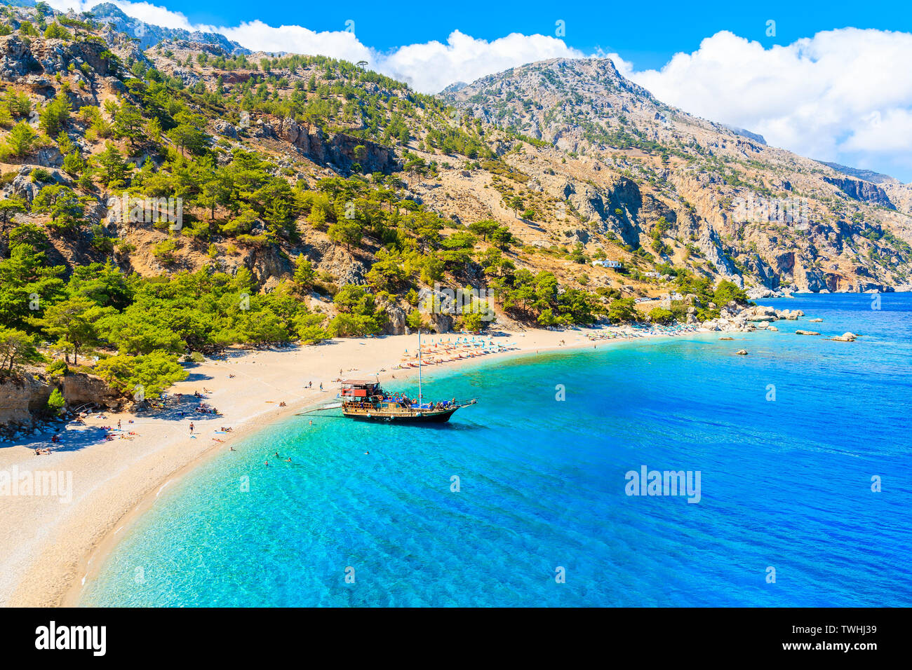 Tourist boat anchoring at beautiful Apella beach on Karpathos island ...
