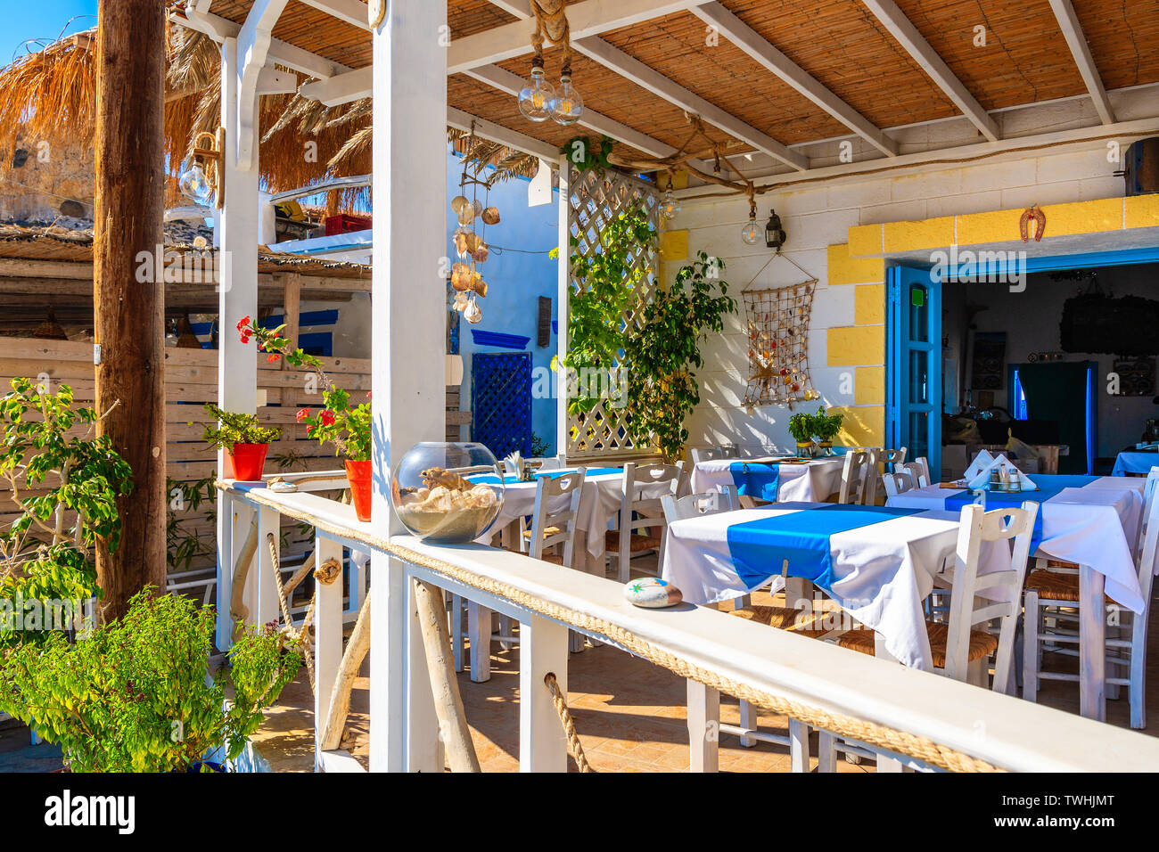 Tables in traditional Greek tavern in Finiki port, Karpathos island ...