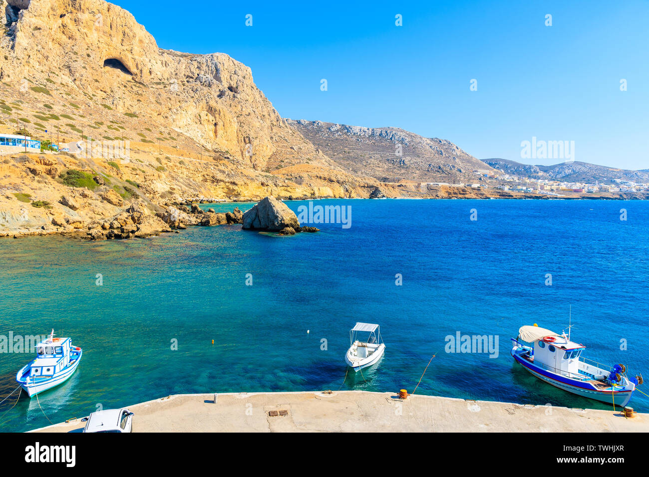 Fishing boats on turquoise sea water in Finiki port, Karpathos island ...