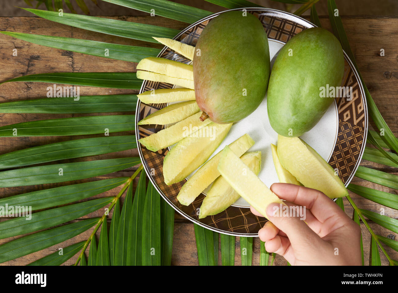 Eating green mango fruit. Healthy diet theme Stock Photo - Alamy