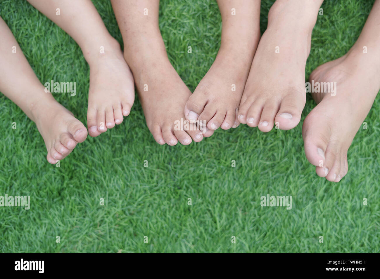 Child's Legs on green grass Stock Photo - Alamy