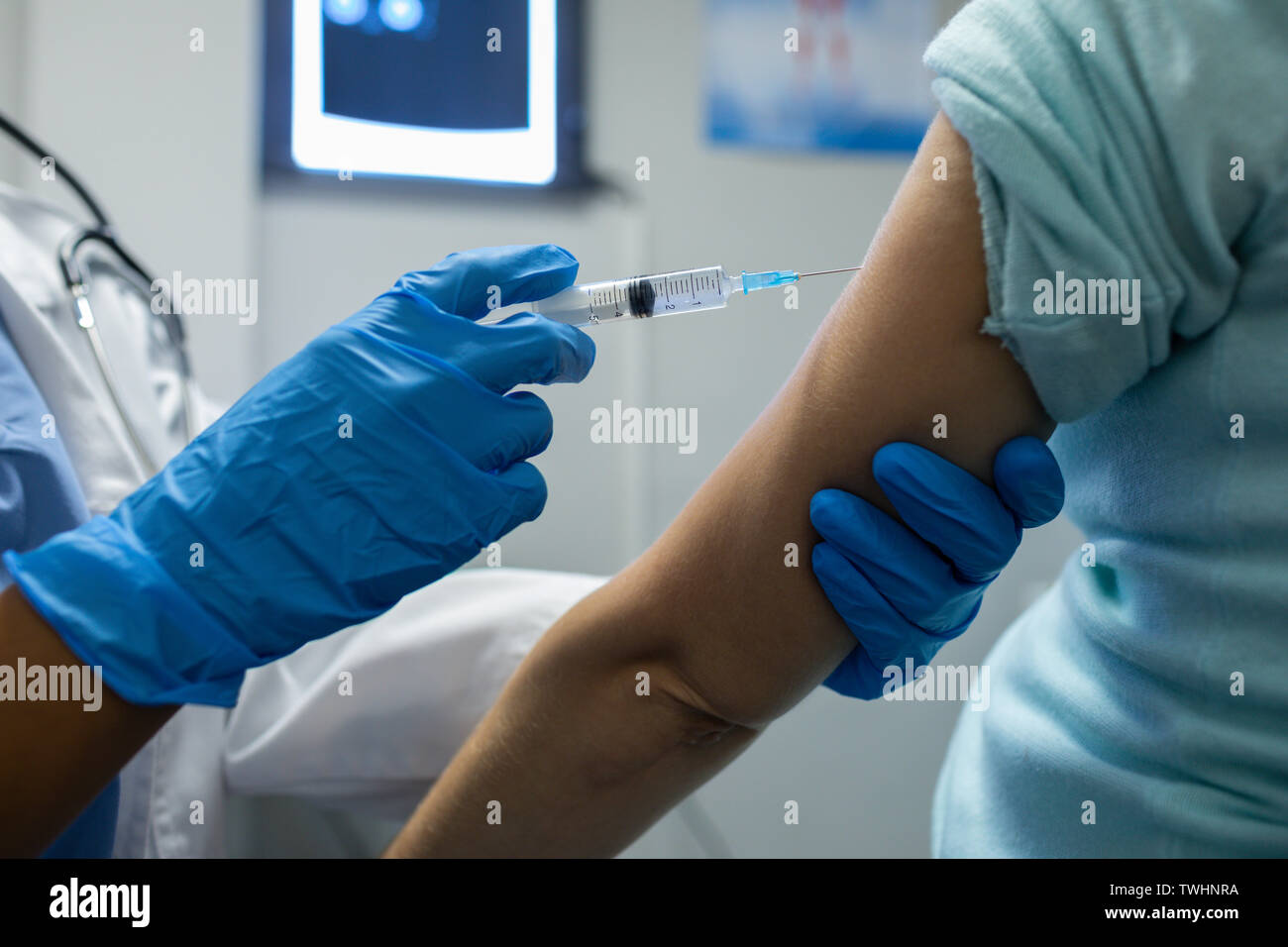 Female doctor giving injection to female patients in the hospital Stock ...