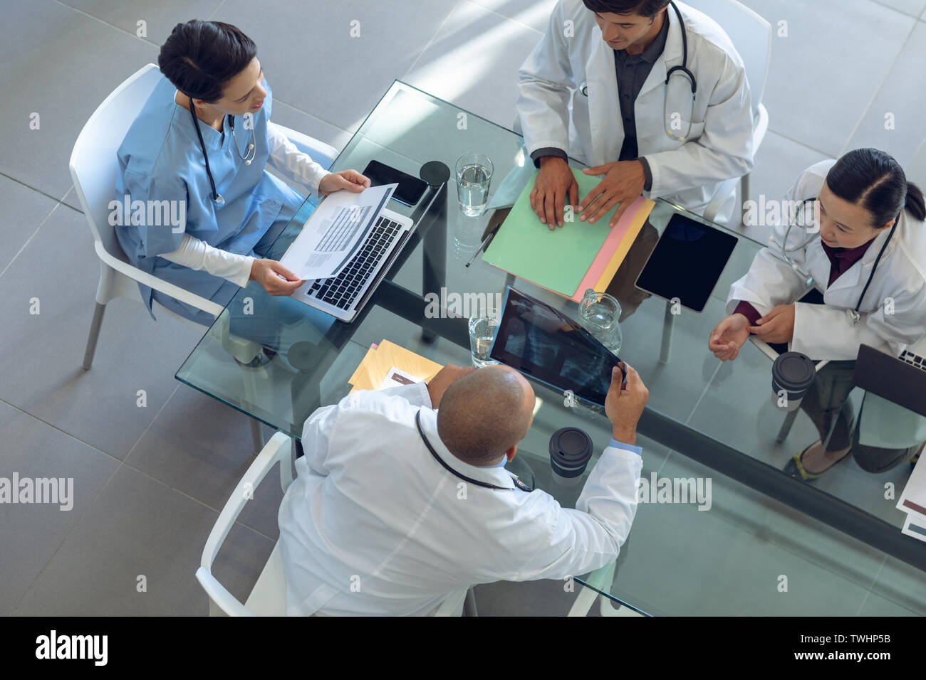 Medical team discussing with each other at the table in hospital Stock ...