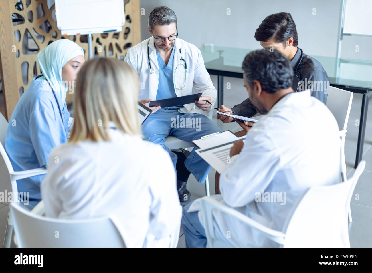 Medical team reading documents together in the hospital Stock Photo - Alamy