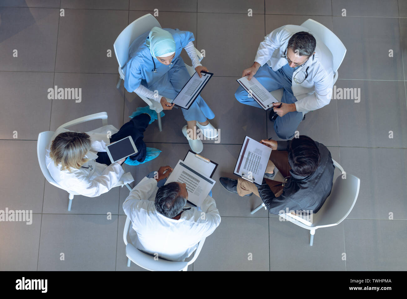 Medical team discussing documents with each other in hospital Stock ...