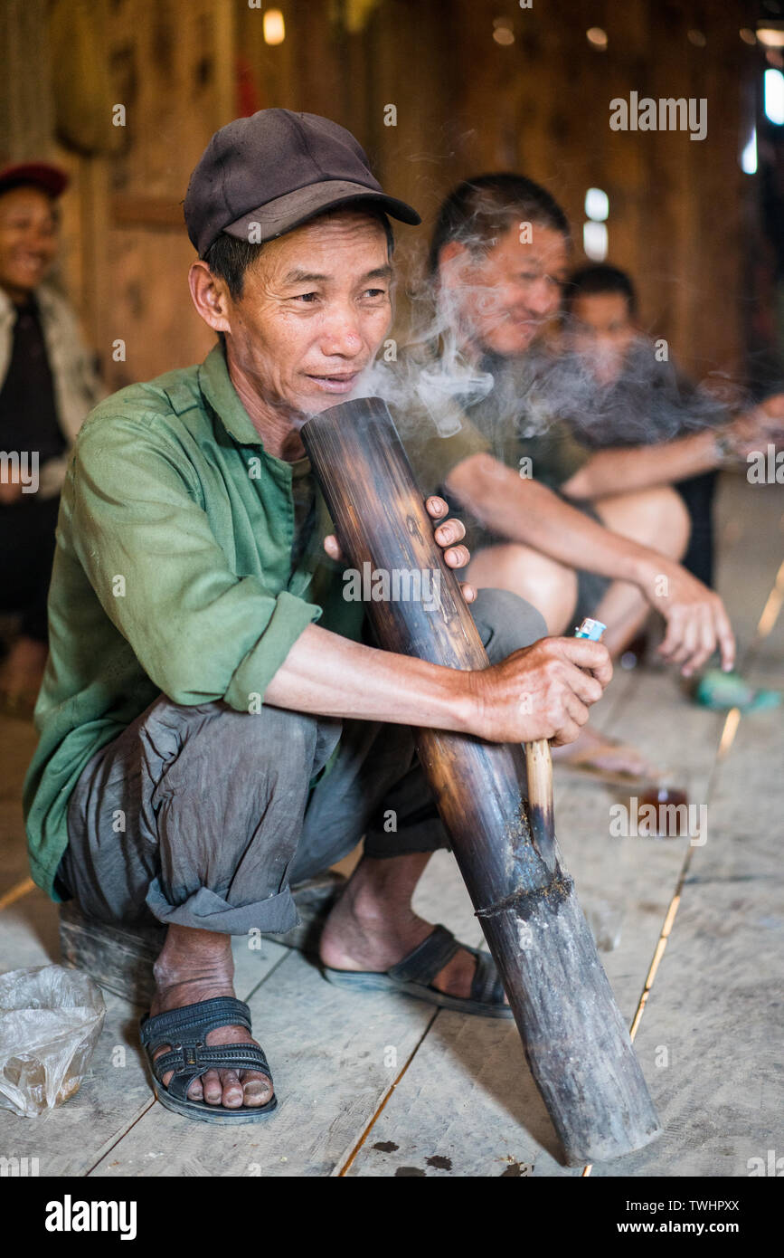 Man Smoking Opium By Traditional Tobacco Pipe In The Akha Pixor Village Near Phongsali Laos