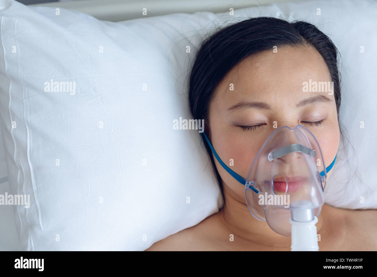 Female patient resting on bed in ward at hospital Stock Photo - Alamy
